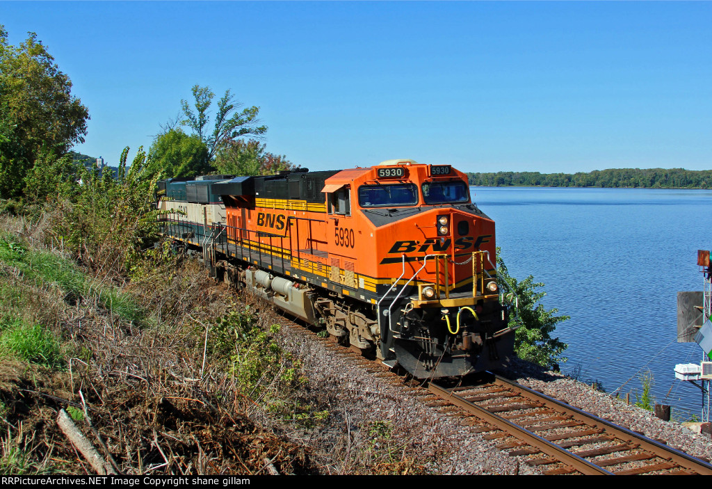 BNSF 5930 Leads a loaded coal next to the Mississippi river.